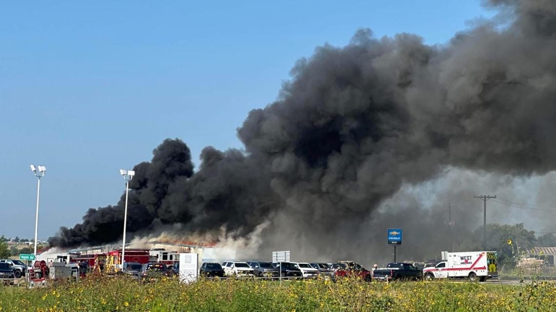 Firefighters tackle major building fire at Chevy of West dealership ...